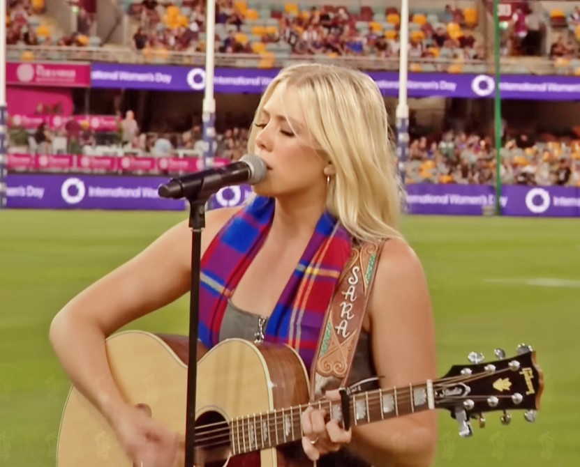 Australian Singer Sara Berki Shines with 'Country Roads' at the Gabba